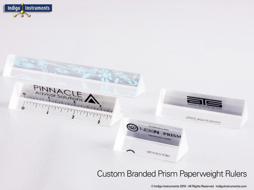 Branded paperweights, glass prism promotional rulers.